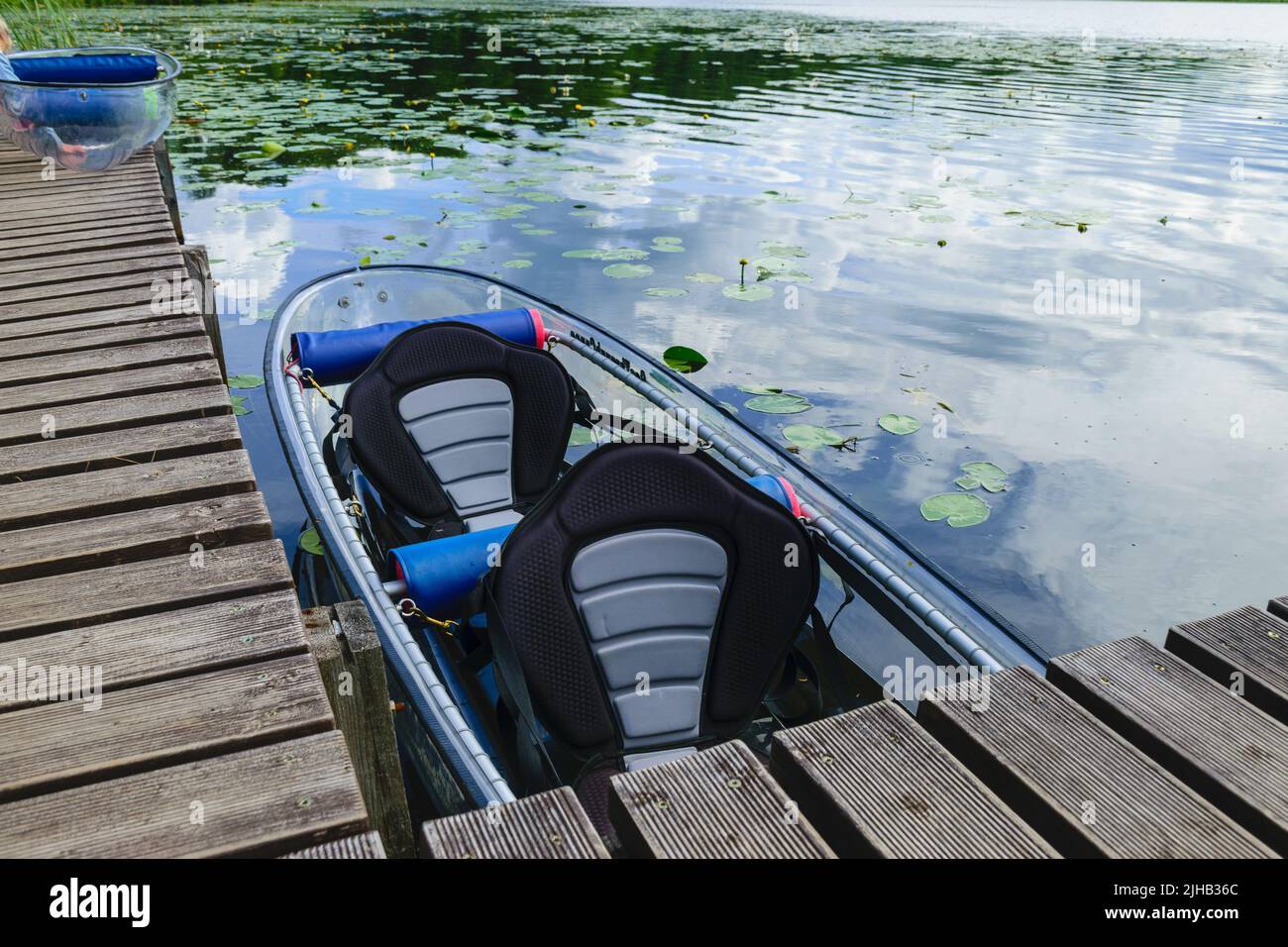 landscape with a transparent plastic boat, exploring a wild lake ...