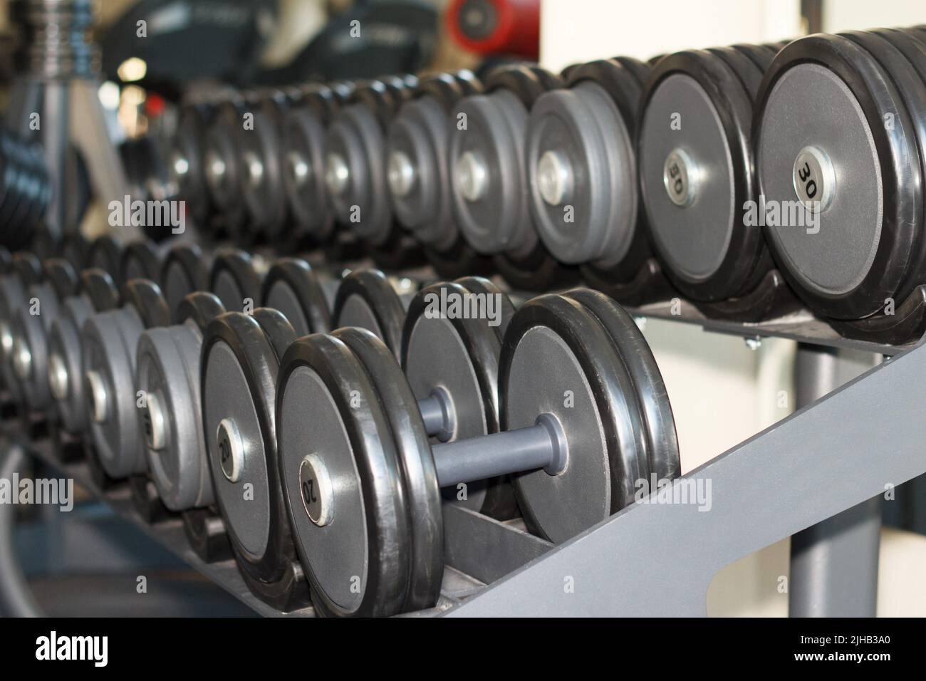 Row barbells in gym hi-res stock photography and images - Alamy