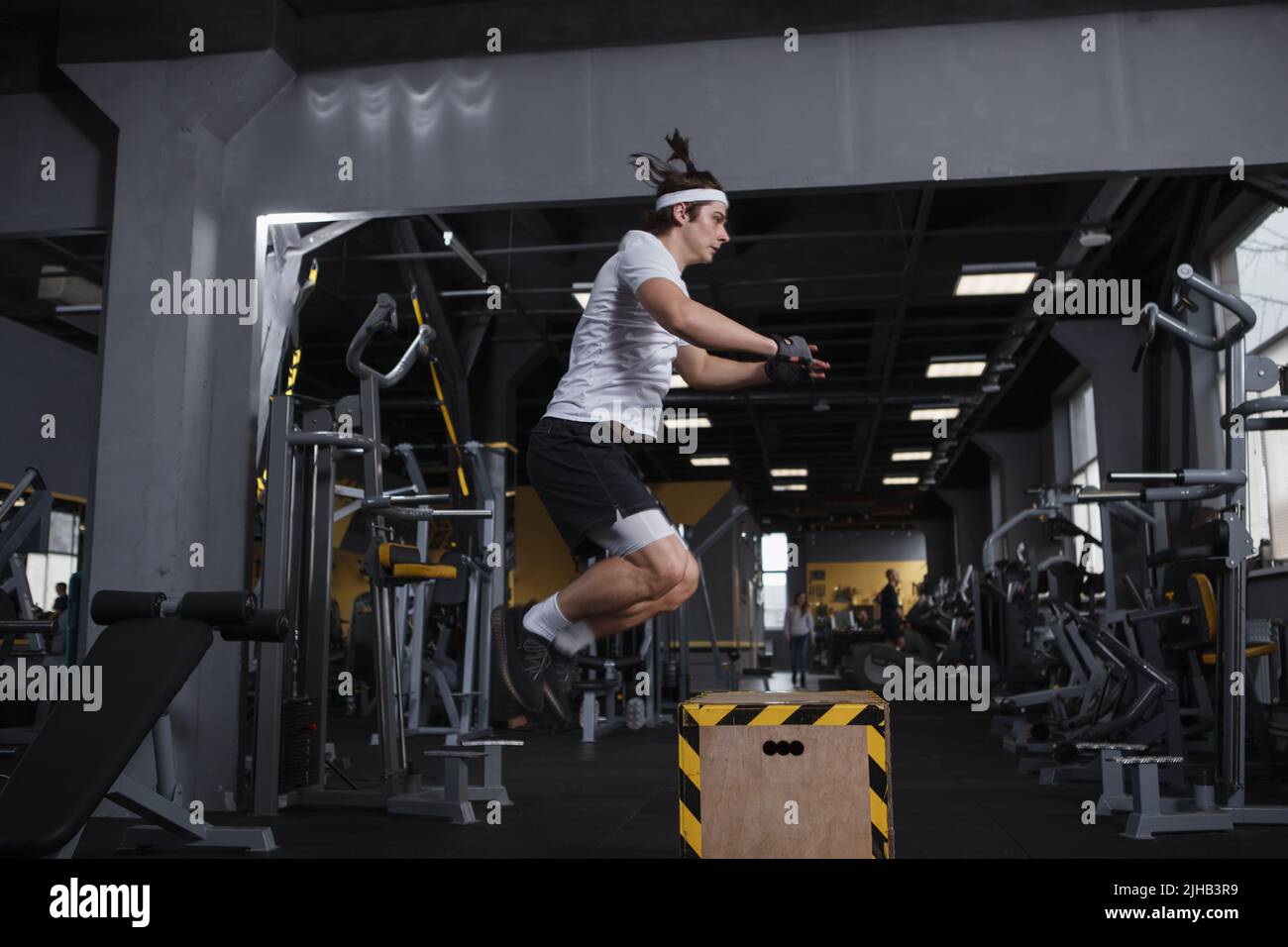 Sportsman doing box jumping workout Stock Photo - Alamy