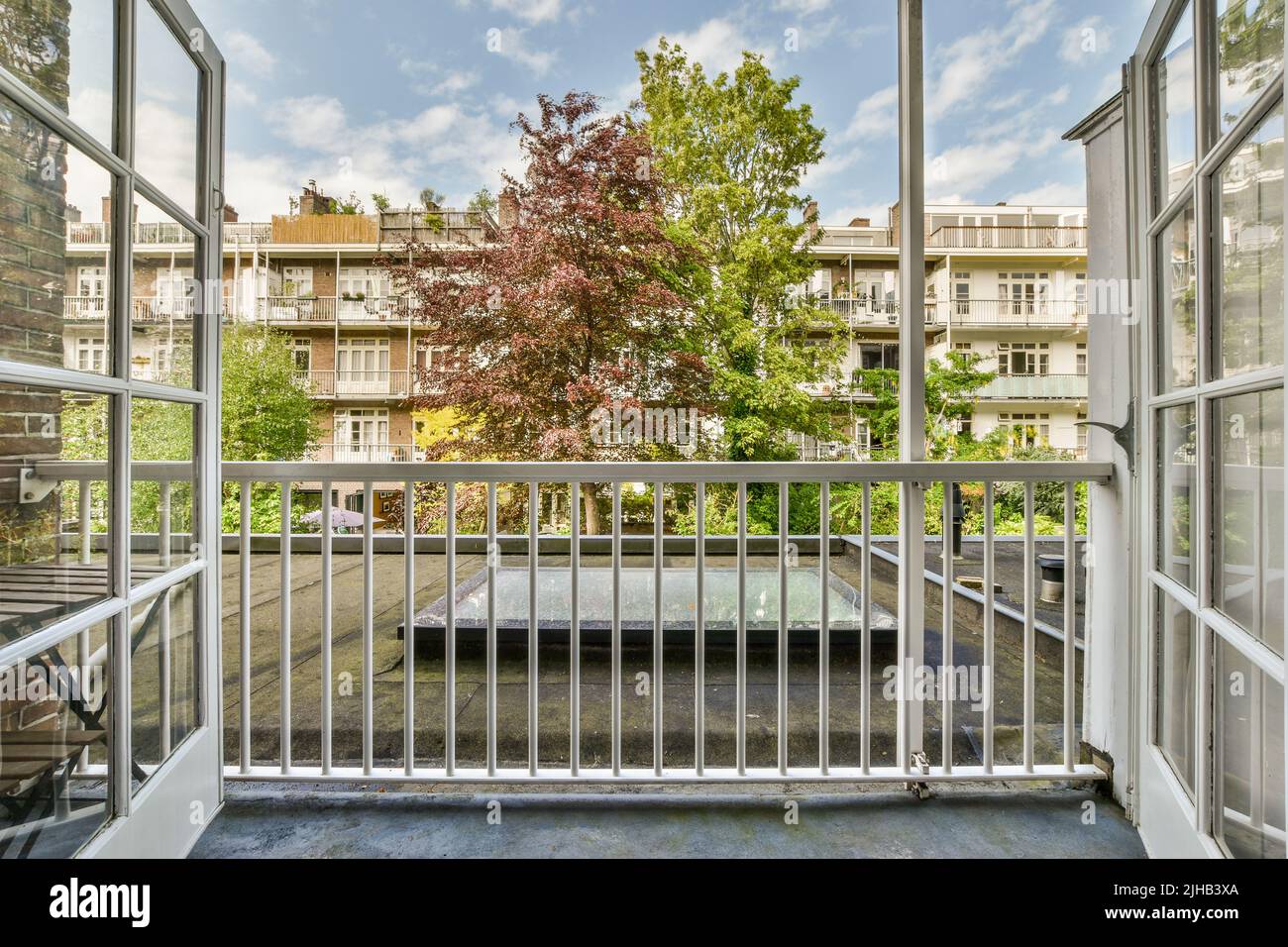 Front view of old brick buildings and cars with bicycles from small ...
