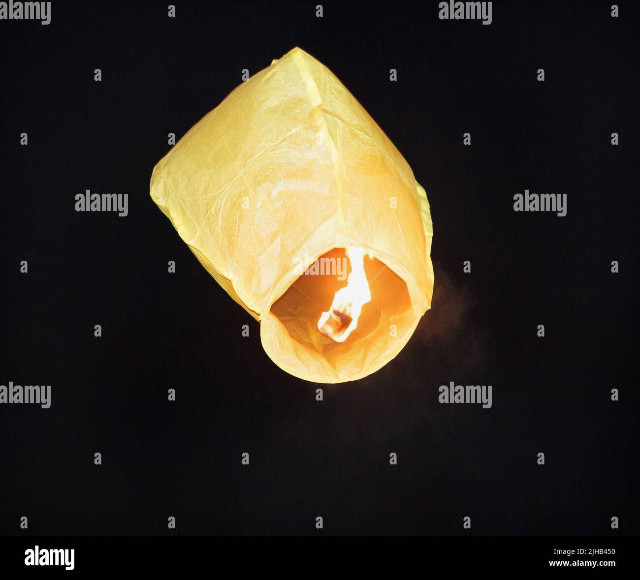 Burning yellow celestial lamp flying to sky Stock Photo - Alamy