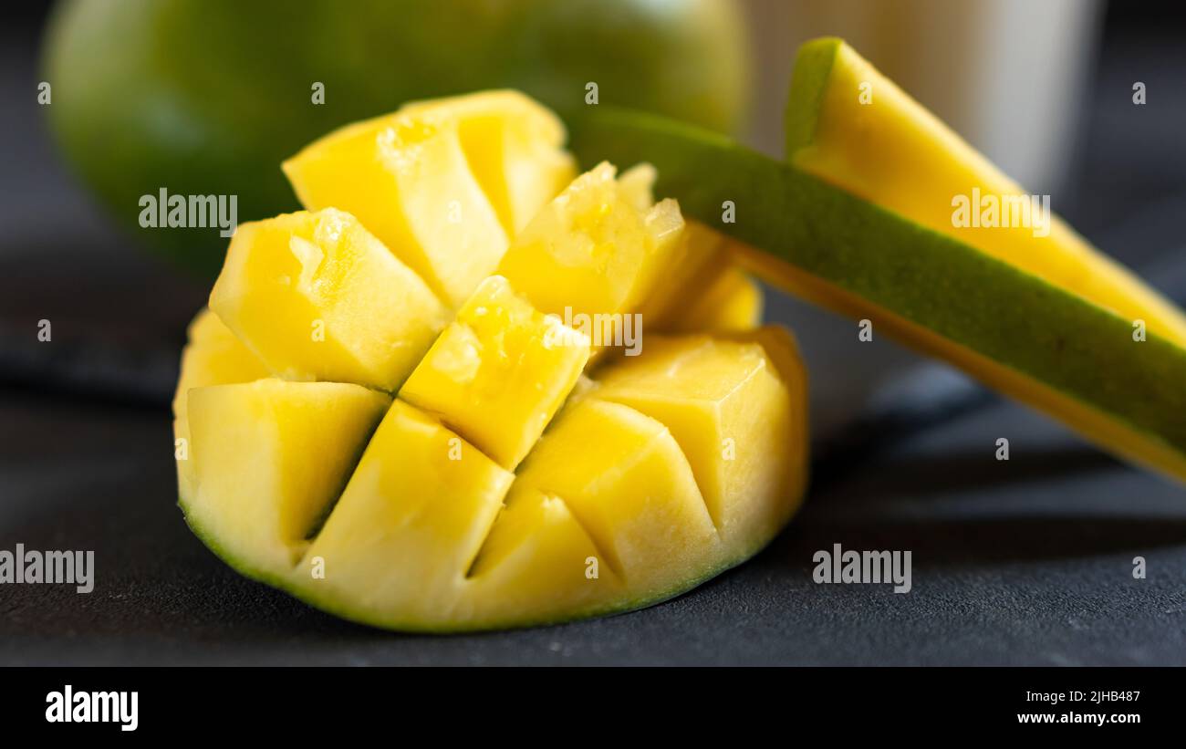 Mango cut on a dark background. Mango in home conditions not neatly cut ...