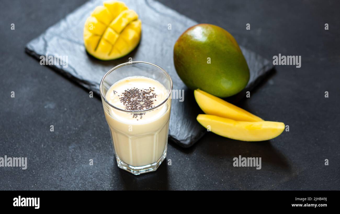 Cool mango milkshake on a black background. A drink to quench your ...