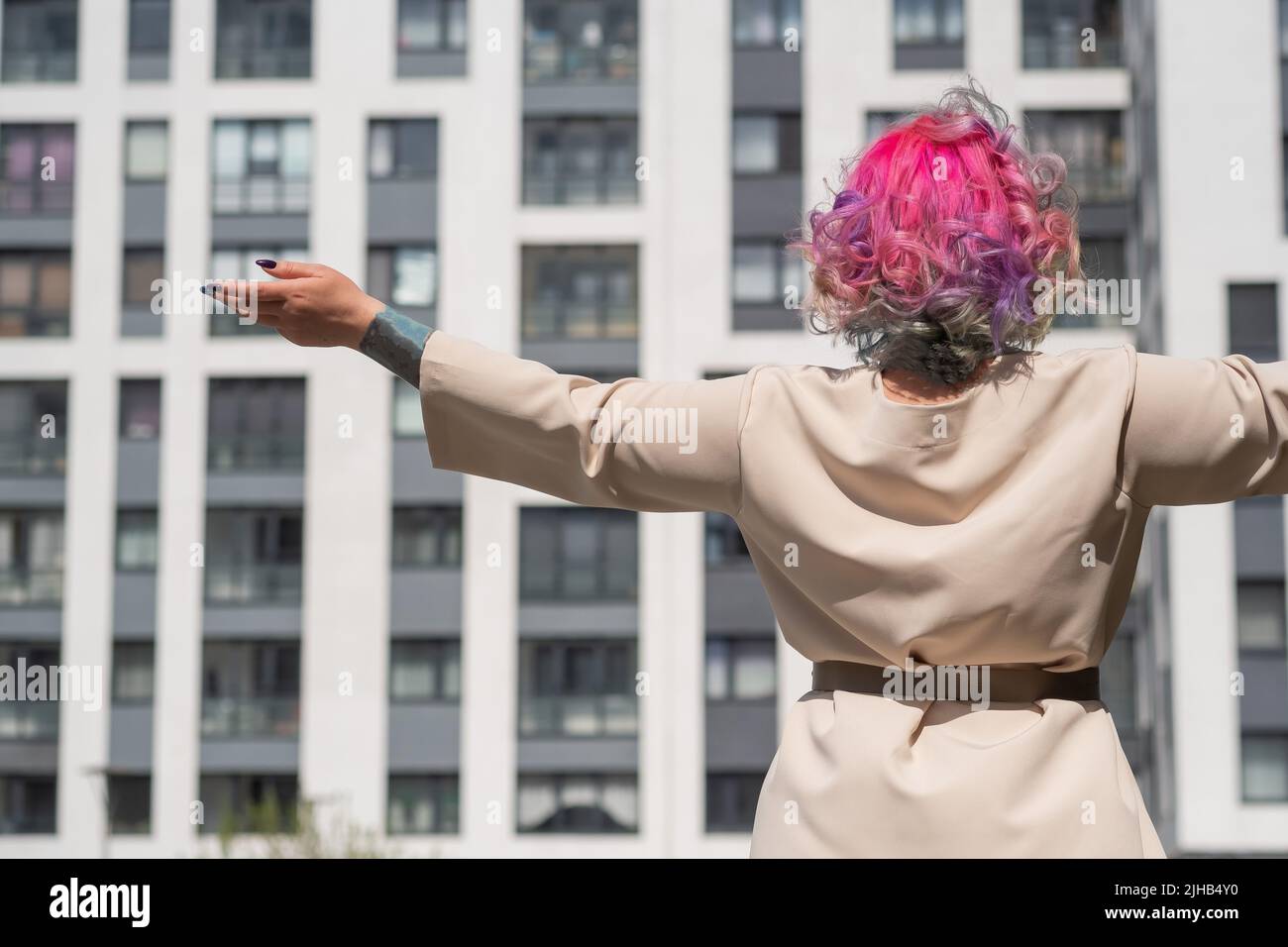 Portrait of a middle-aged woman with multi-colored hair walks on the ...
