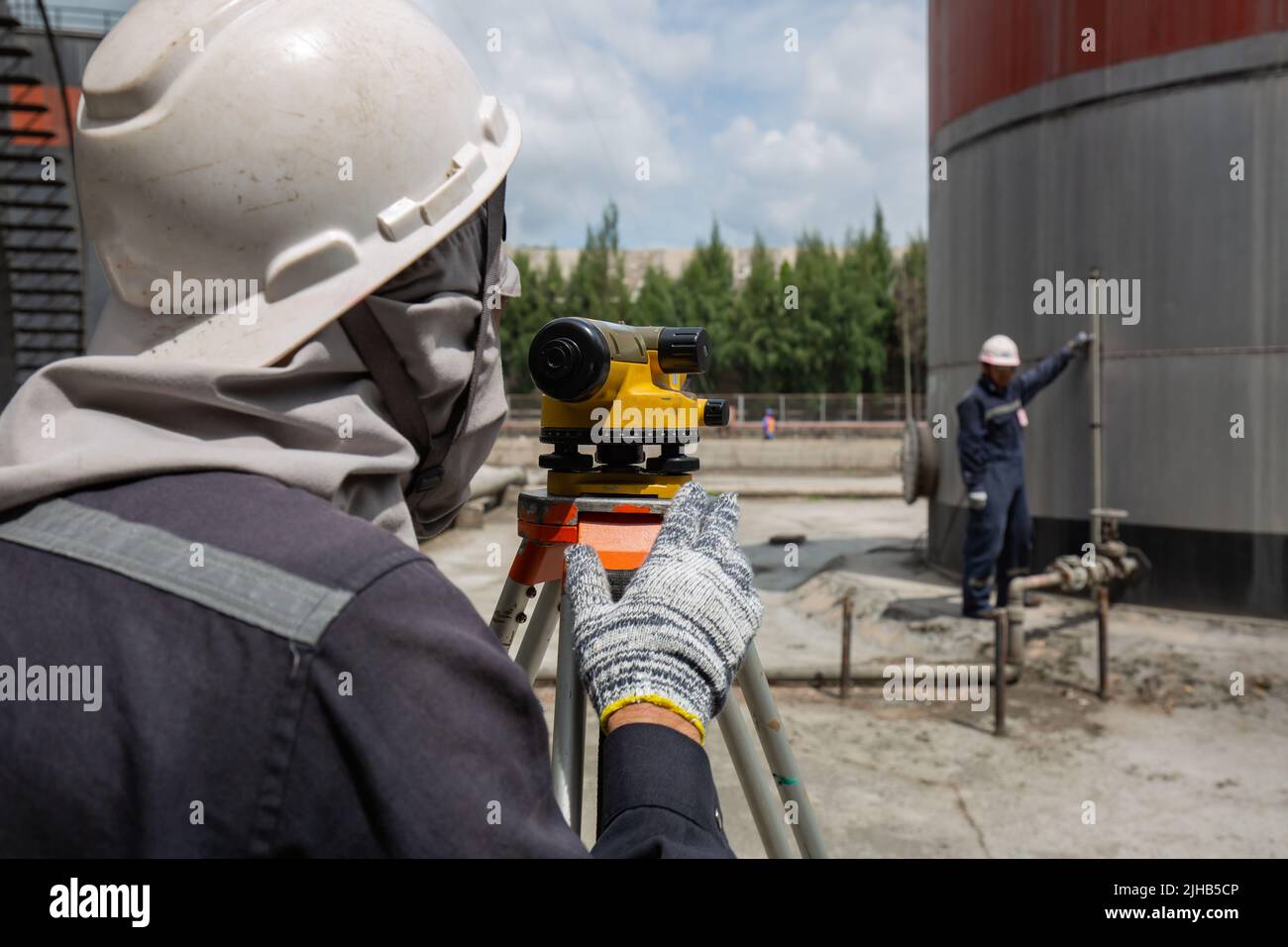 Male worker inspection survey level of storage tank Stock Photo - Alamy