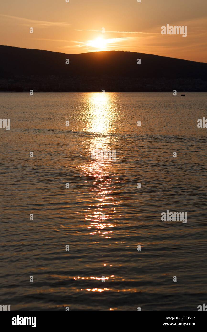 Sunset over water at the sea Stock Photo - Alamy