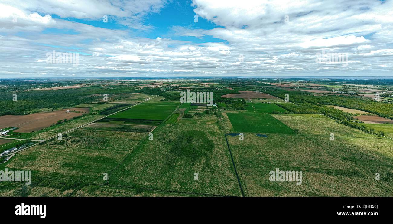 A very wide aerial view of farmland and rural wisconsin in spring under ...