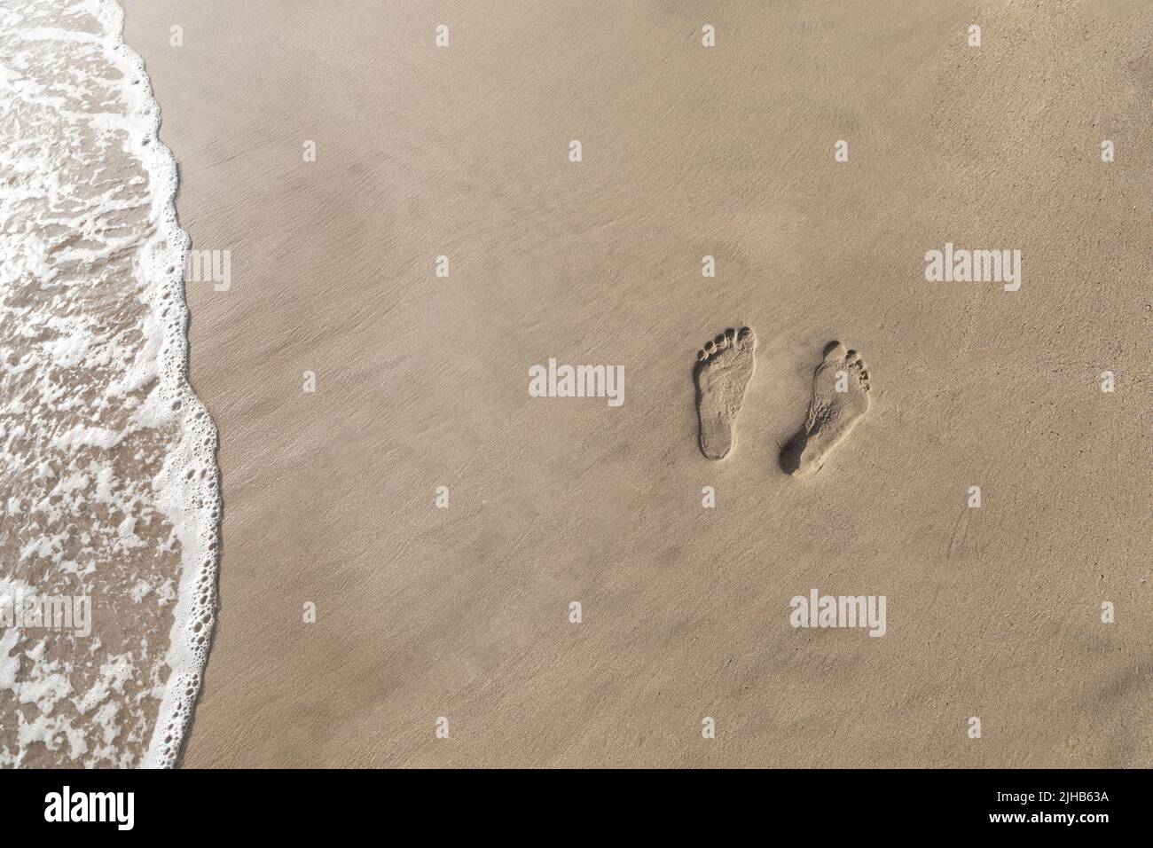 Two footsteps in the sand on a walk in Maui Hawaii Stock Photo - Alamy