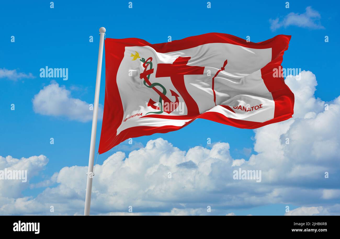 official flag of Psara Greece at cloudy sky background on sunset ...