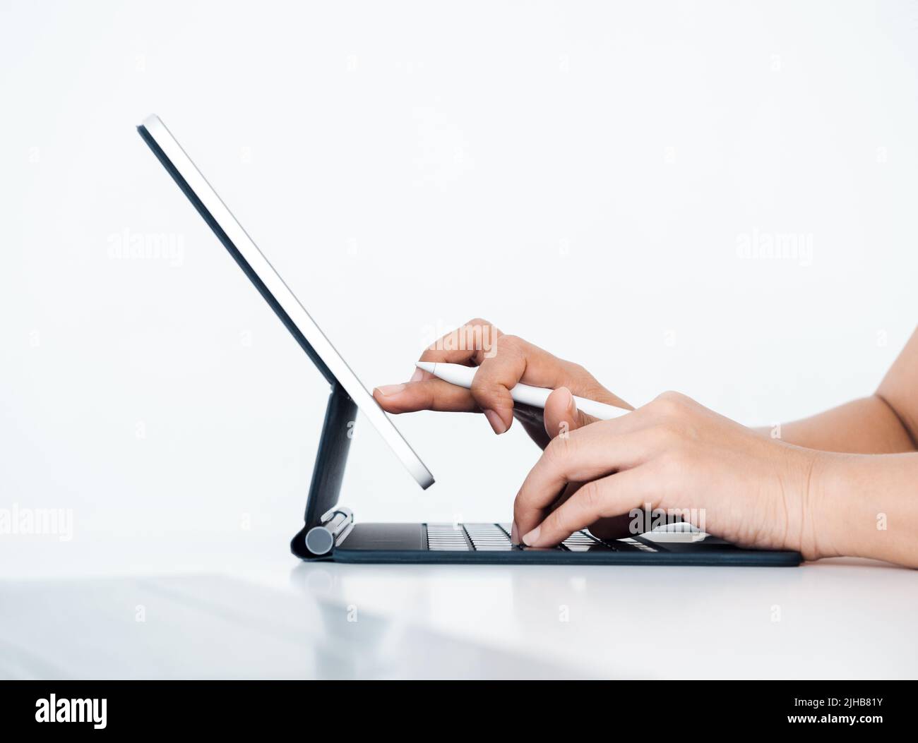 Hand holding white electronic pen or pencil, touching on screen on ...