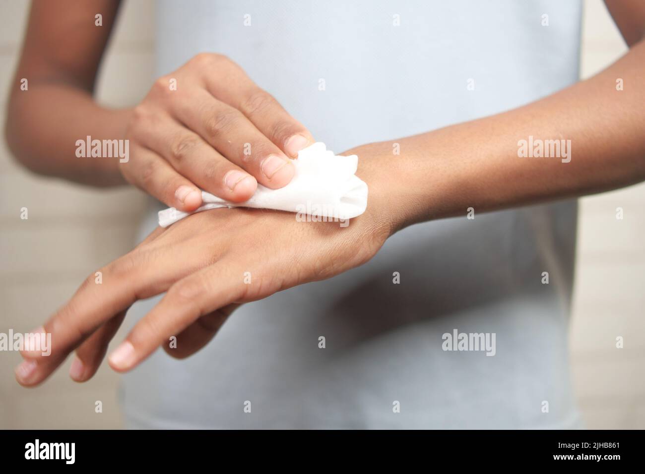 man disinfecting his hands with a wet wipe Stock Photo - Alamy