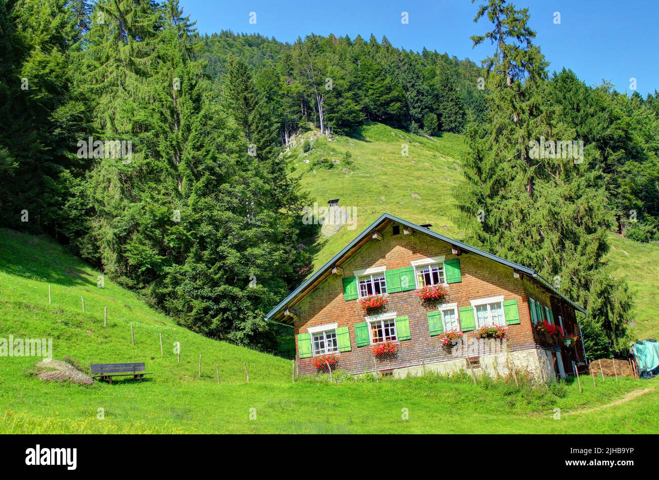 A beautiful shot of a tilting house on the base of a hill in a rural ...