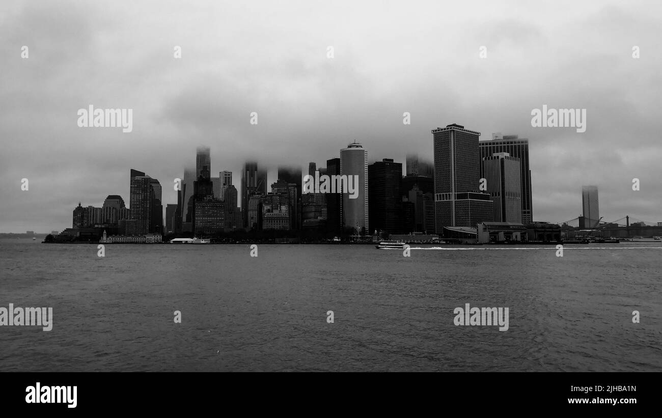 A grayscale shot of the Manhattan skyline in New York City on a gloomy ...