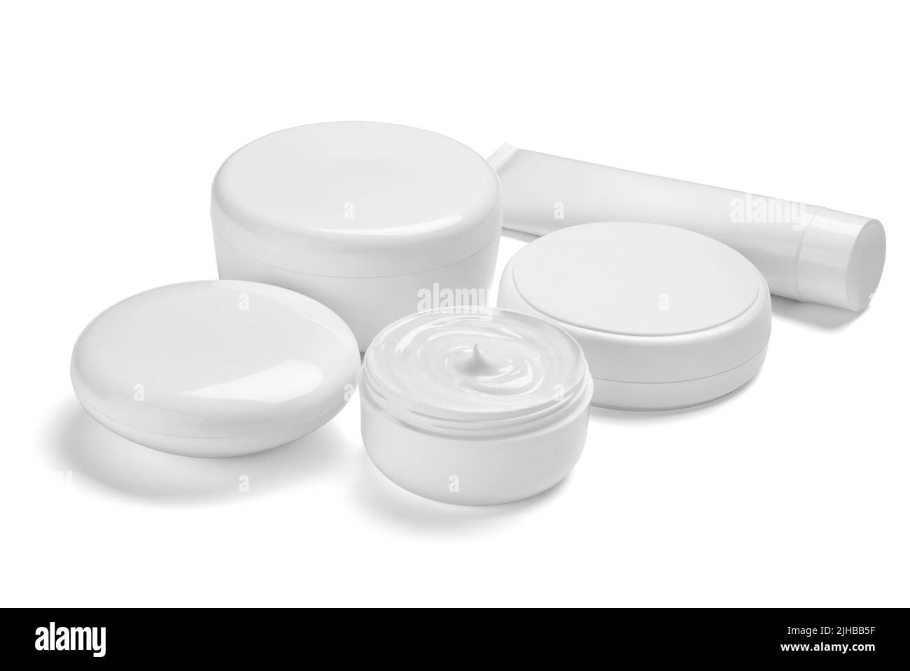 close up of a white beauty cream container and tube on white background ...
