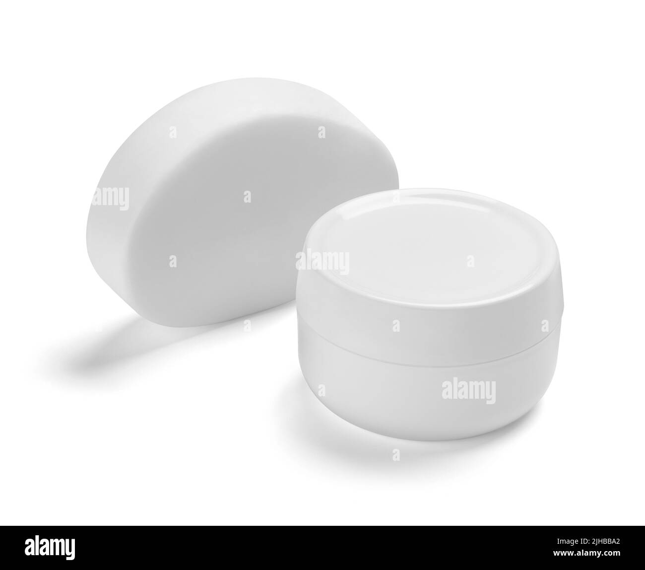 close up of a white beauty cream container and tube on white background ...