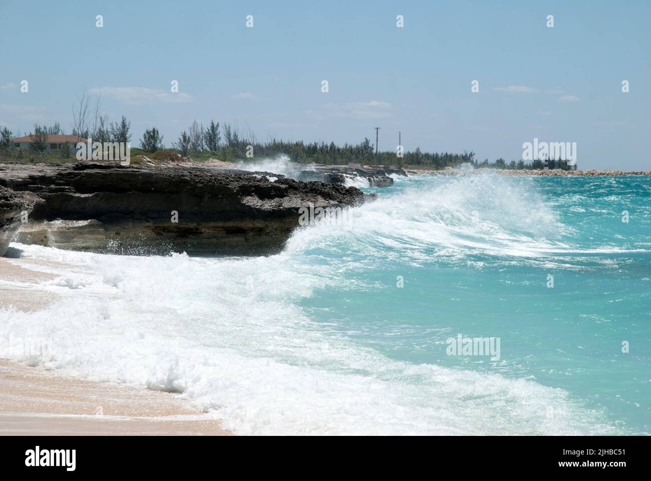 The view of powerful waves washing the beach and rocky shore on Grand ...