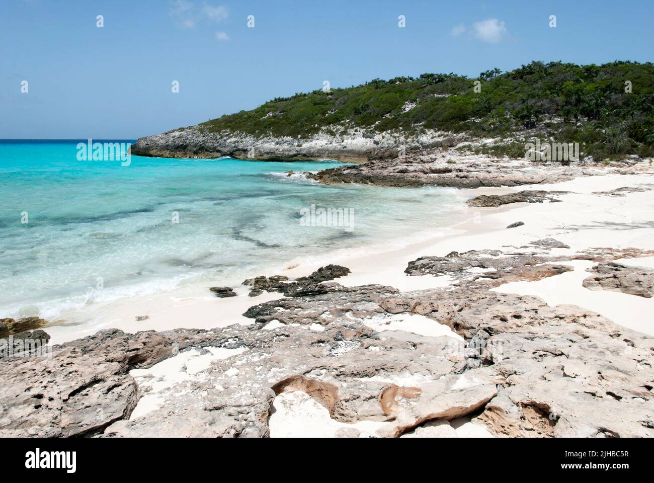 The view of sandy rocky beach and turquoise color water on uninhabited ...
