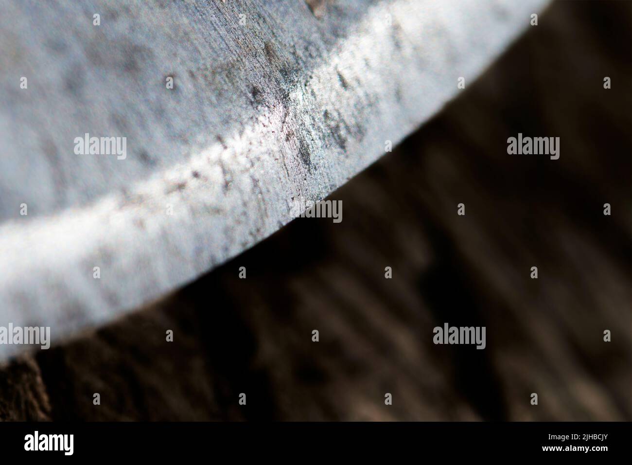 Extreme close-up of a steel cutting tool with a curved sharpd for ...