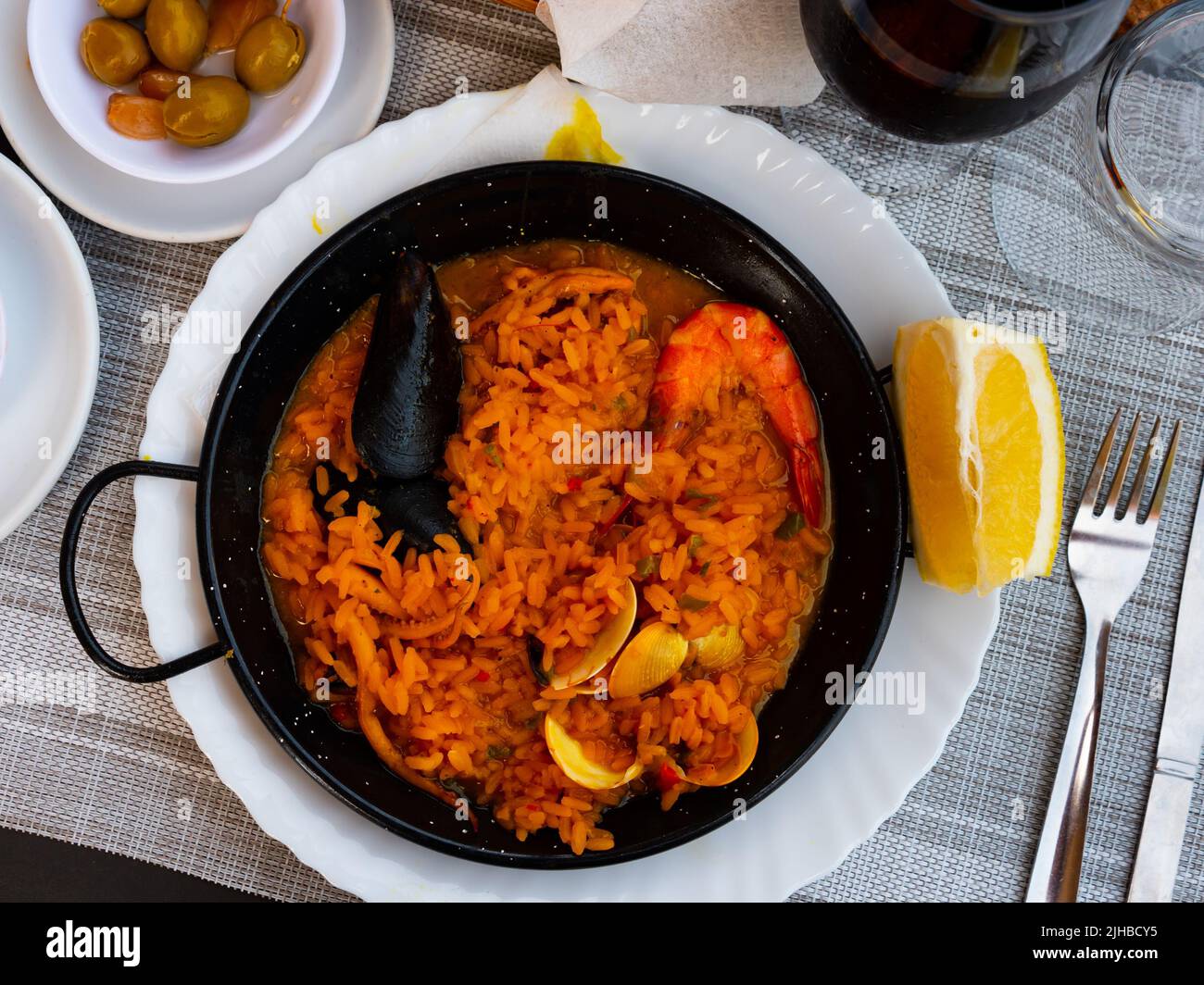 Spanish rice dish paella tinted with saffron. Prepared with olive oil ...