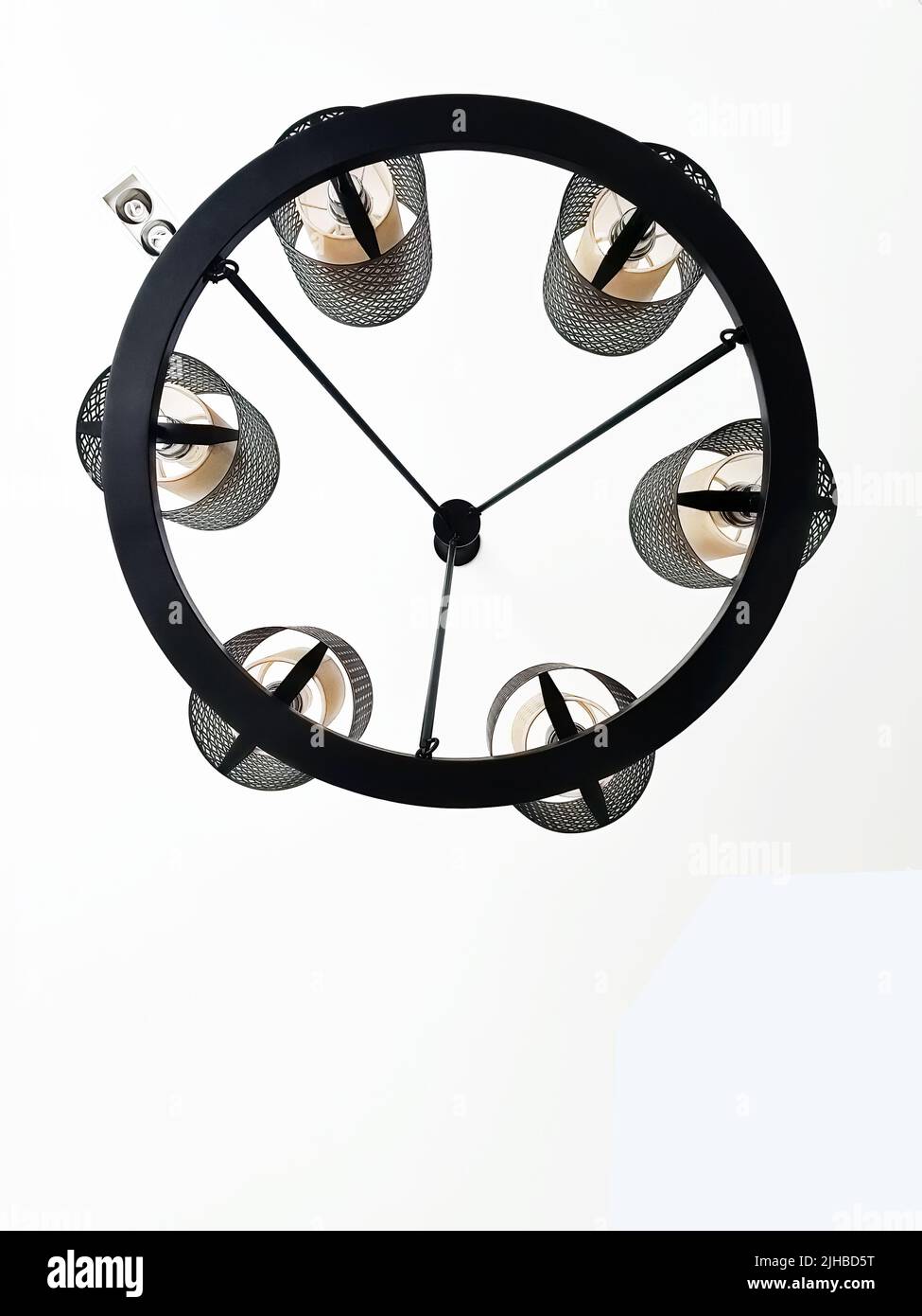 Low angle view of geometric circle shape of electric lamp hanging on ...