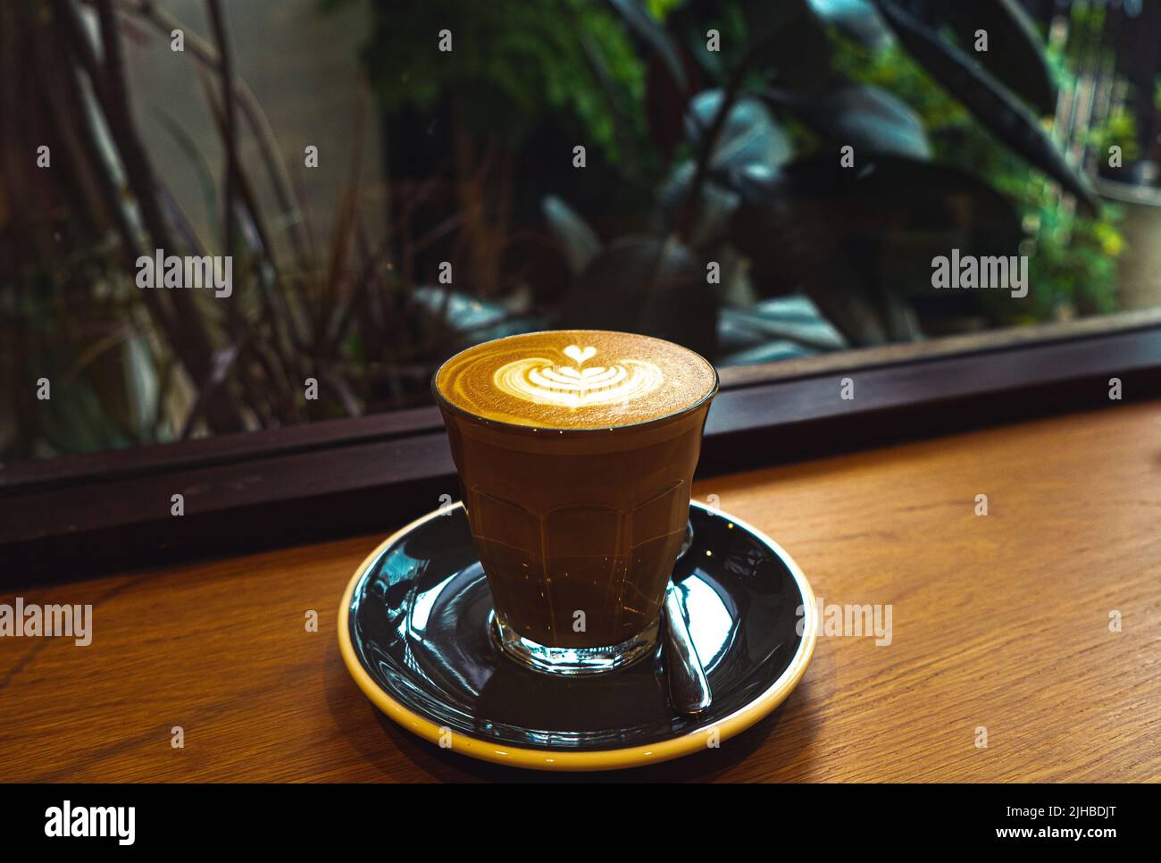 A cup of coffee latte top view with Microfoam milk leaf shape foam ...
