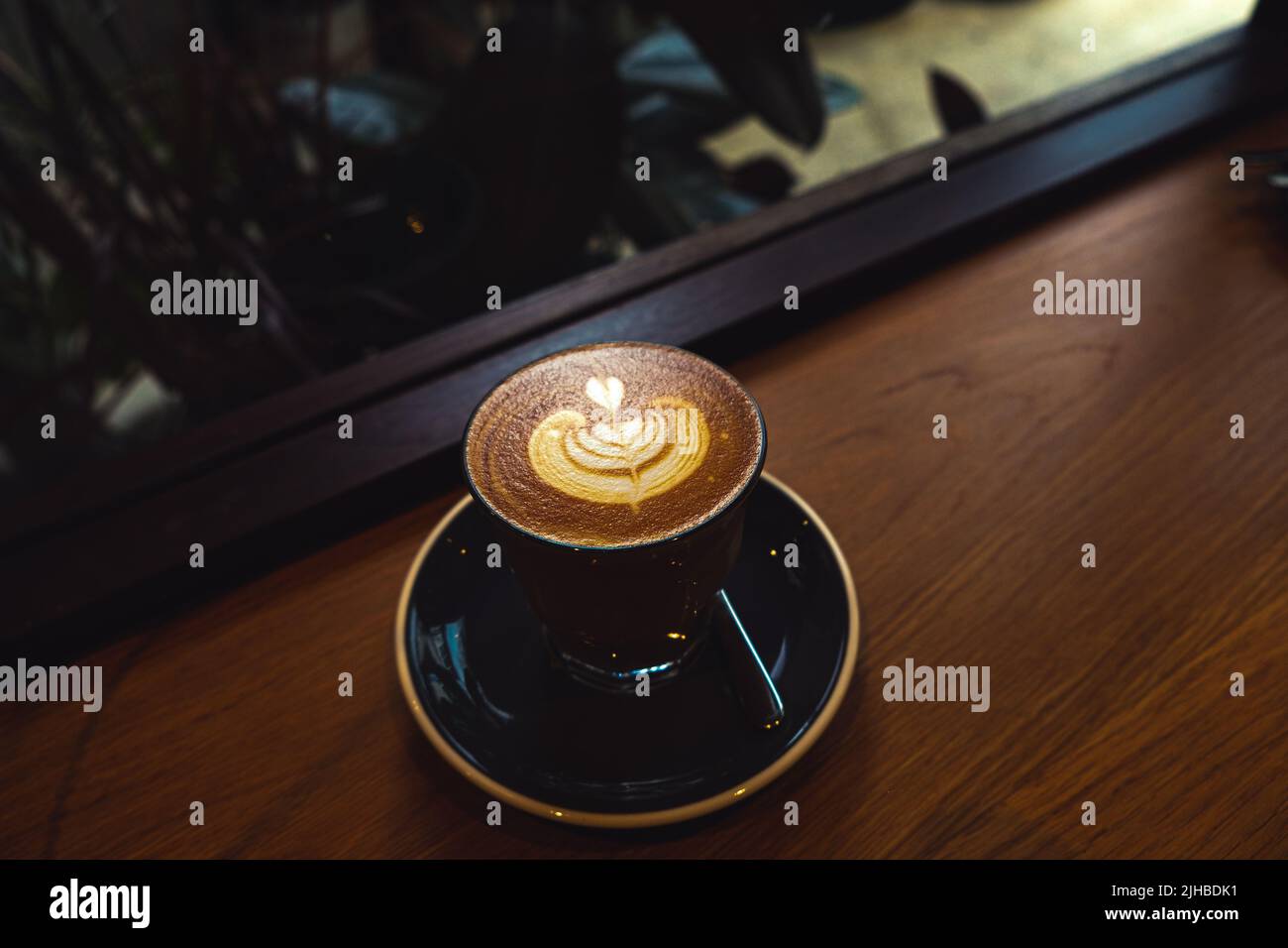 A cup of coffee latte top view with Microfoam milk leaf shape foam ...