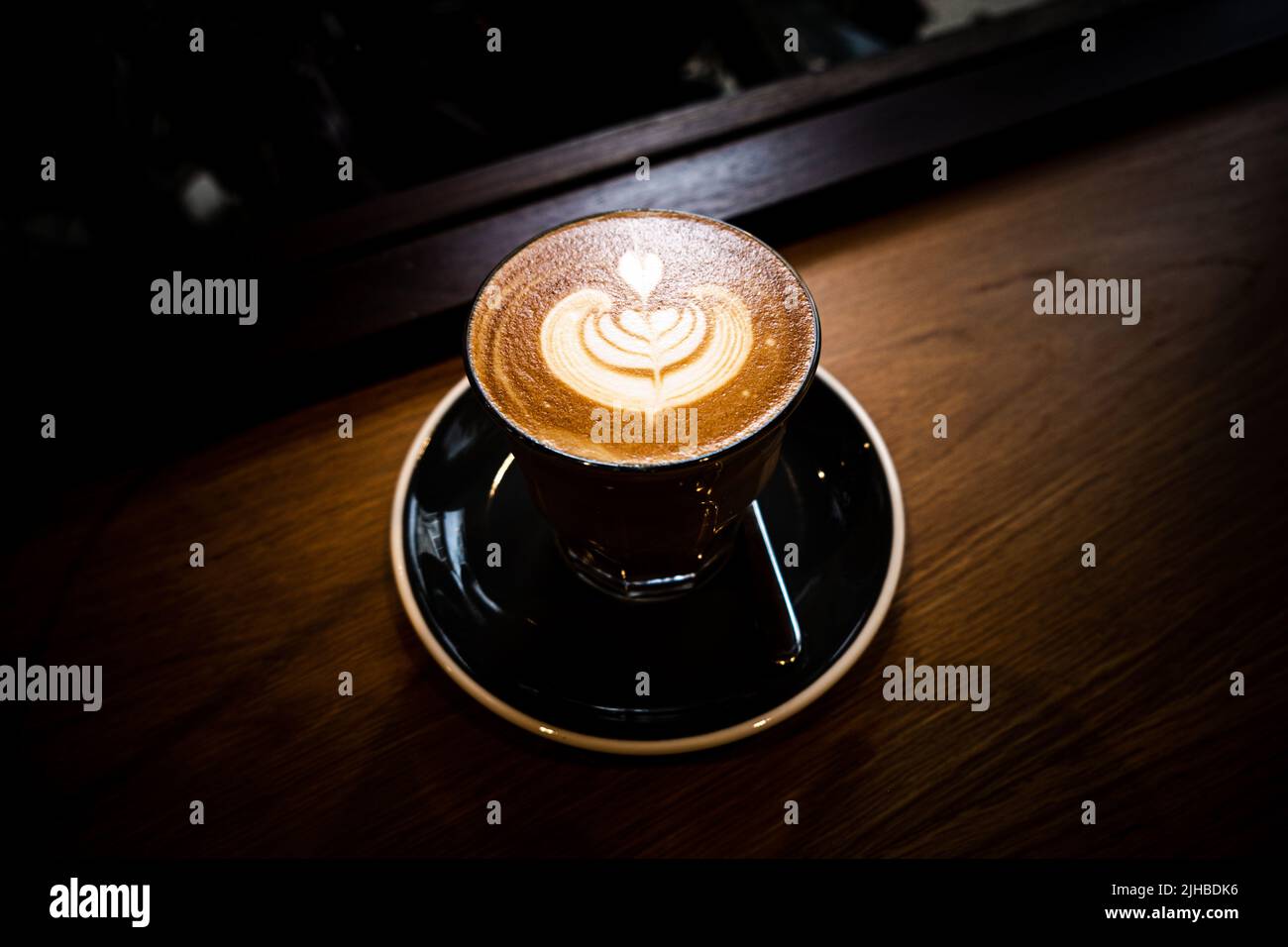A cup of coffee latte top view with Microfoam milk leaf shape foam ...