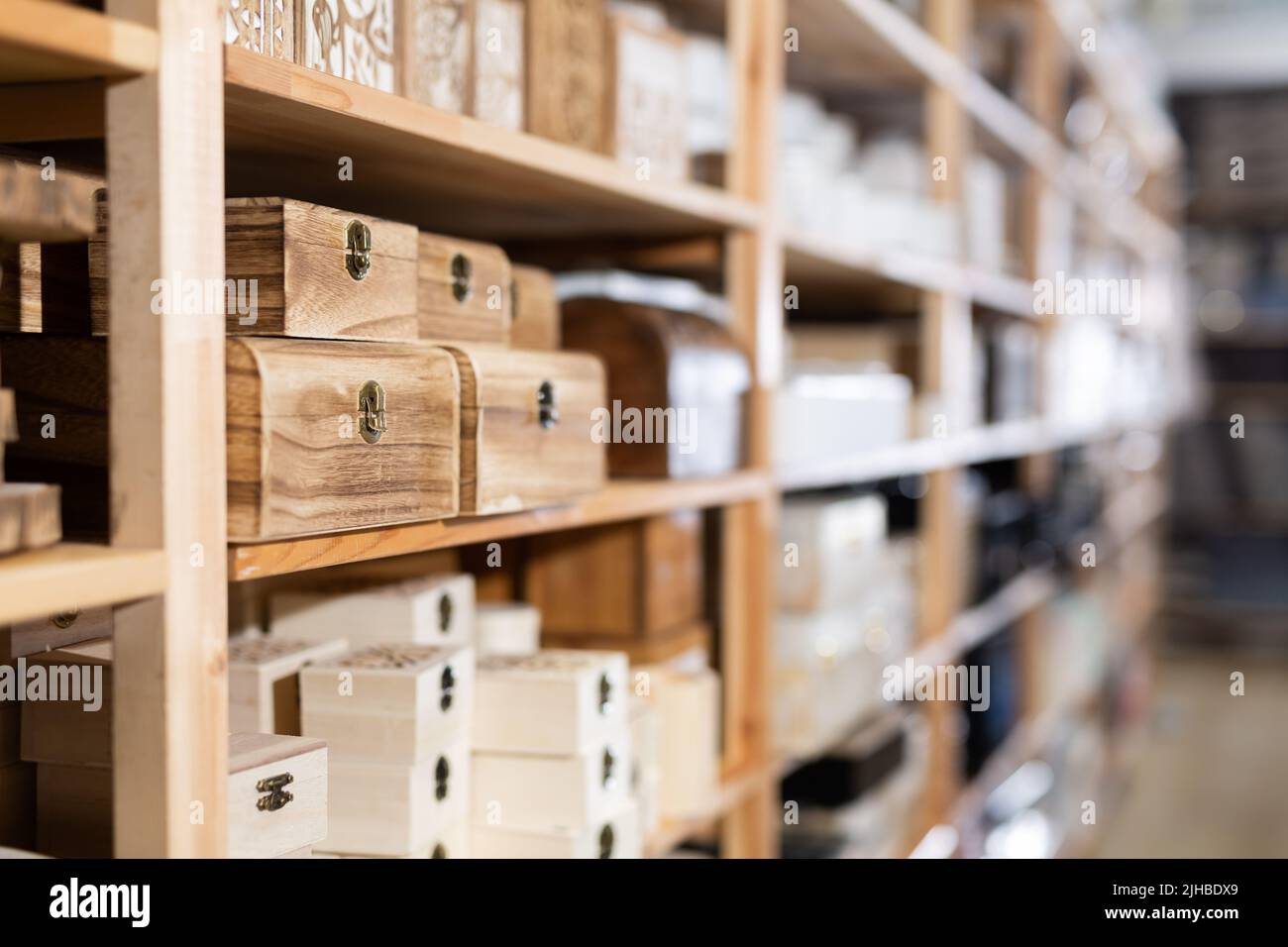 Decorative wooden jewelry storage caskets on shelves in store Stock ...