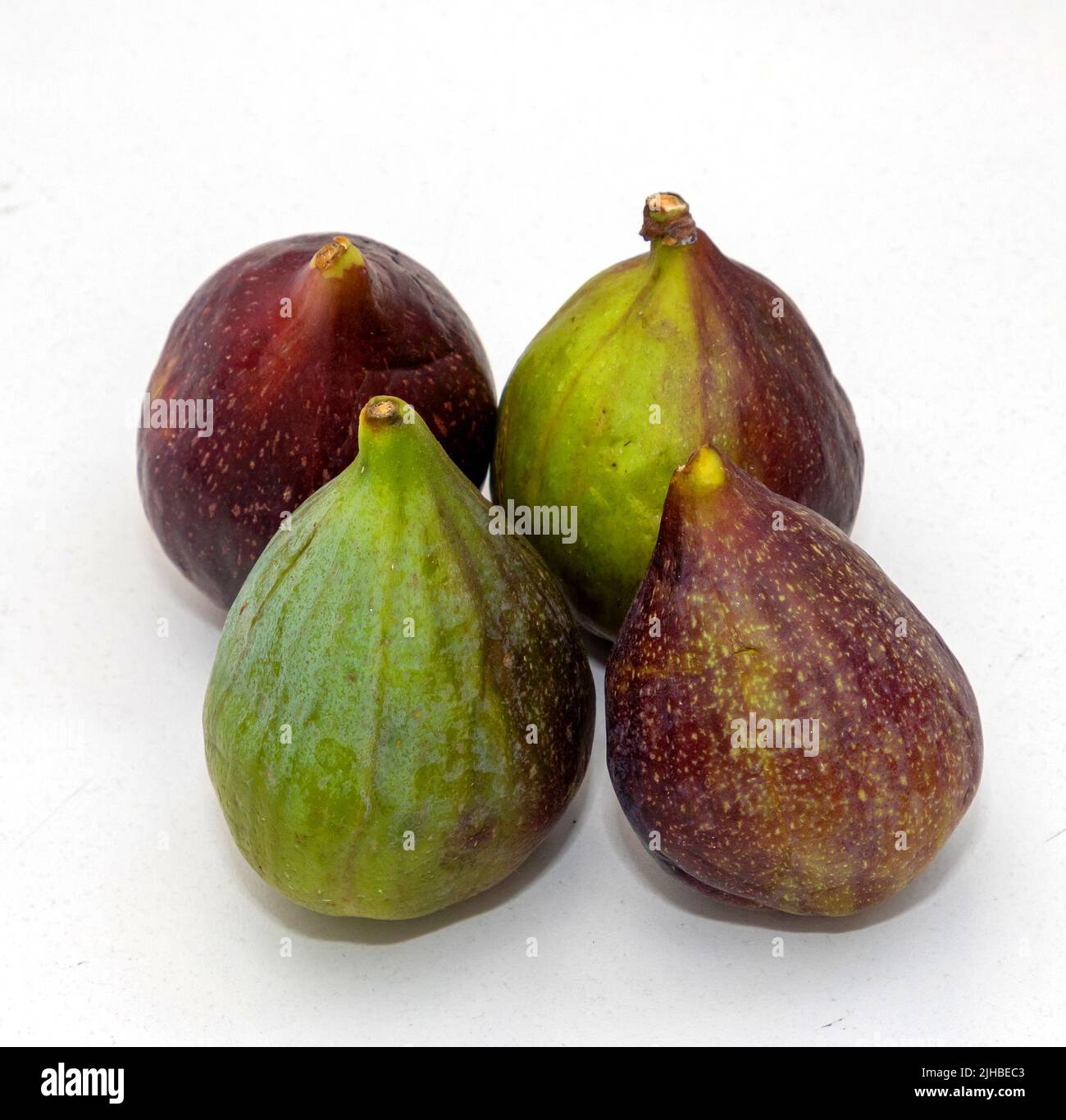 Fresh organic green and purple figs isolated on white background Stock ...