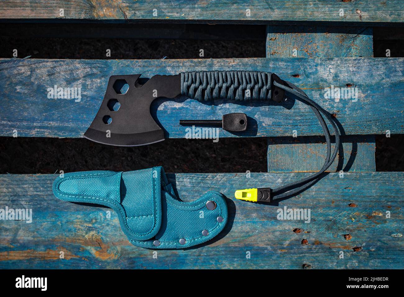 A small black ax with a paracord-wrapped handle. A tool for cutting ...