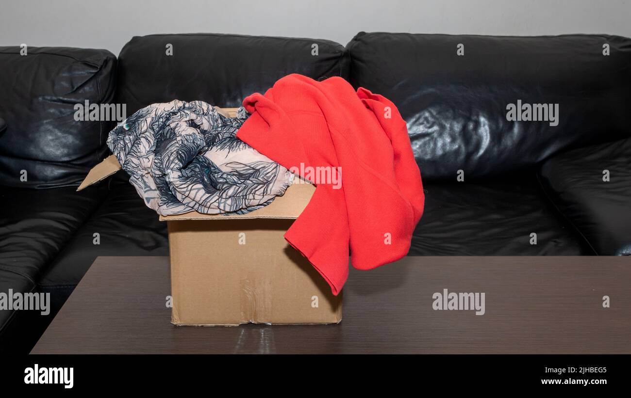 Open cardboard box clothes hi-res stock photography and images - Alamy