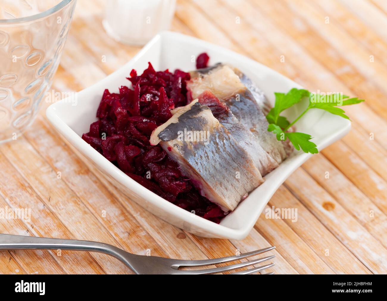 Sliced marinated herring with boiled grated beetroot and greens Stock ...