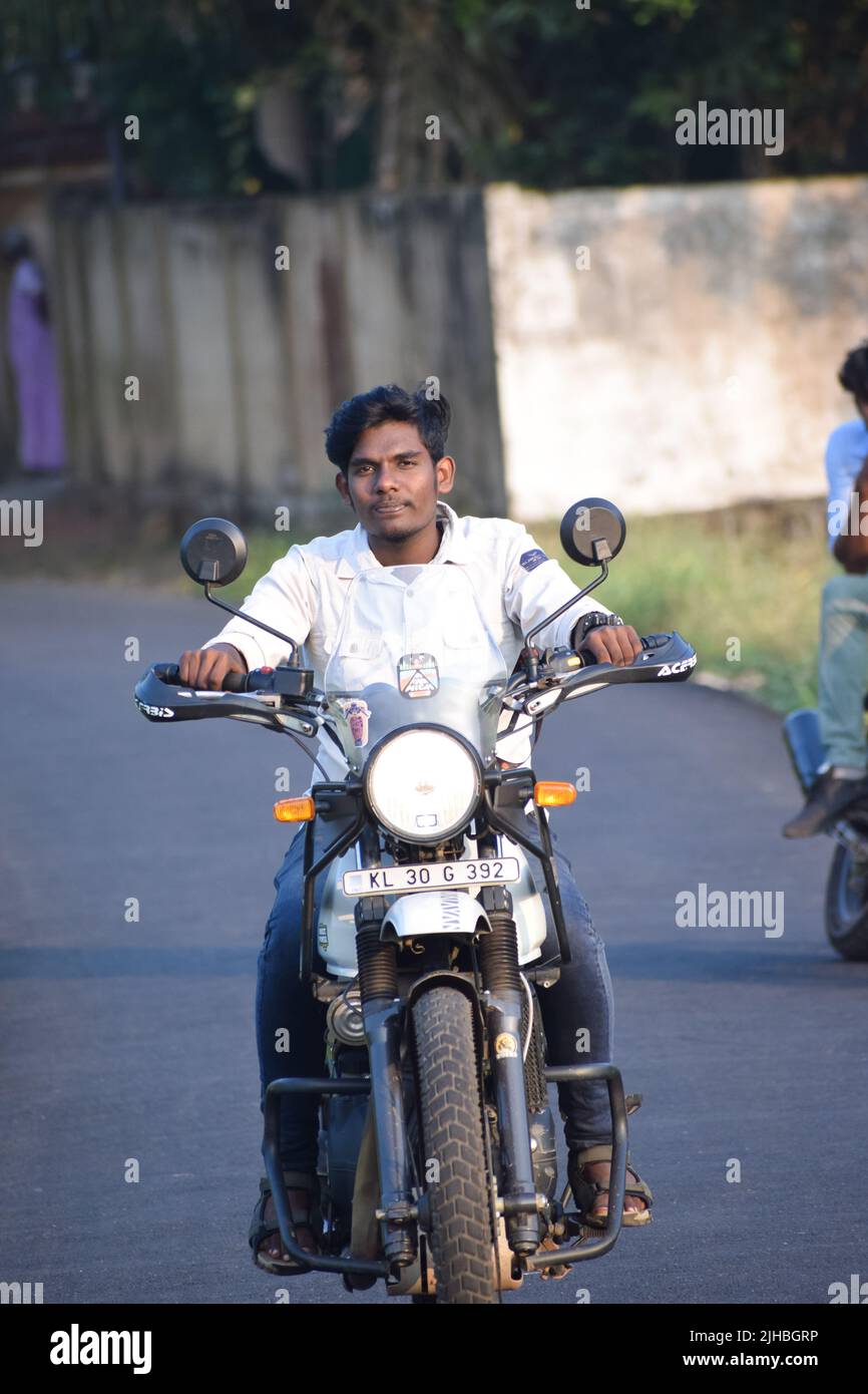 An indian young man riding a motorcycle near a paddy field Stock Photo ...