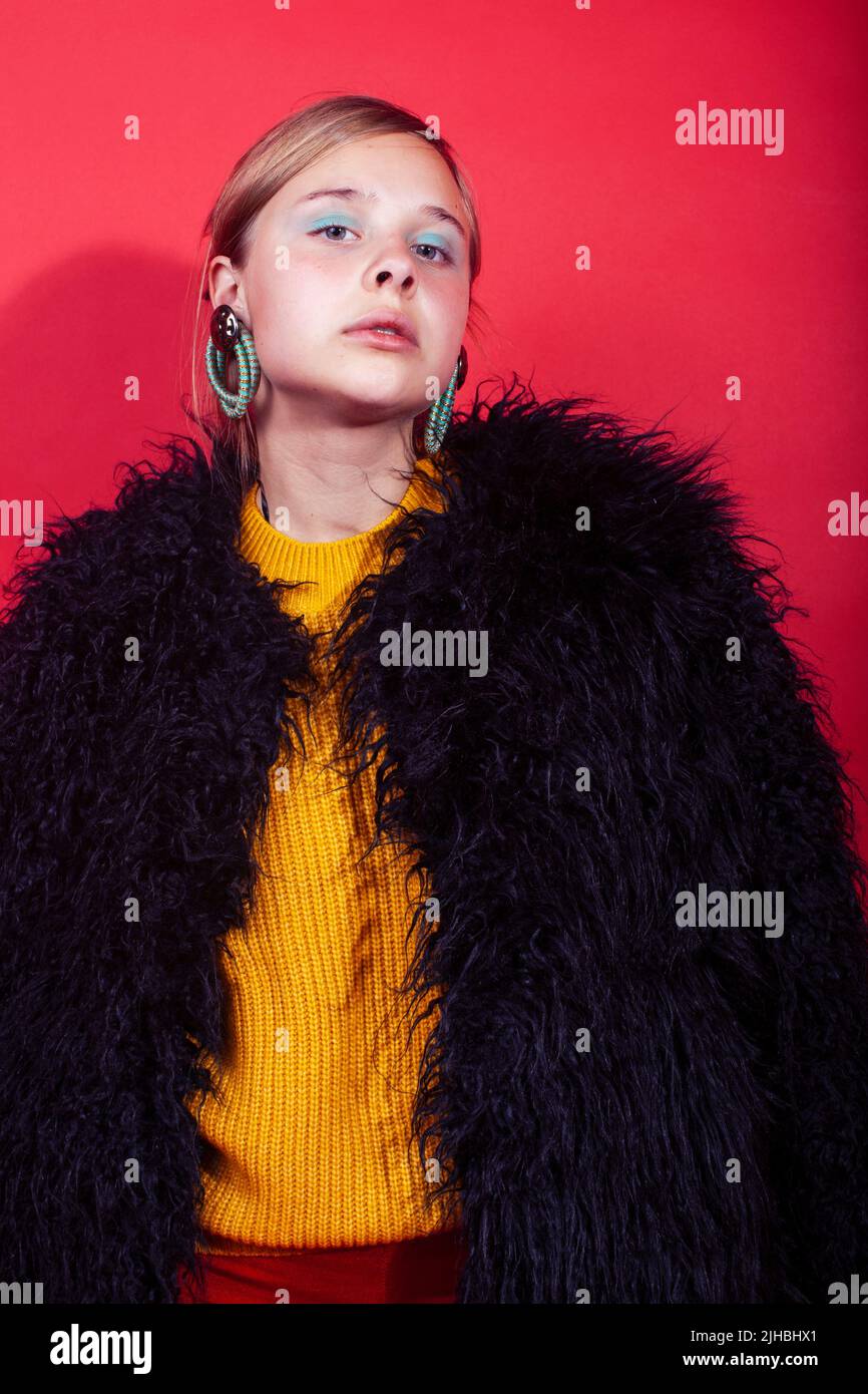 young pyoung pretty emitonal posing teenage girl on bright red ...