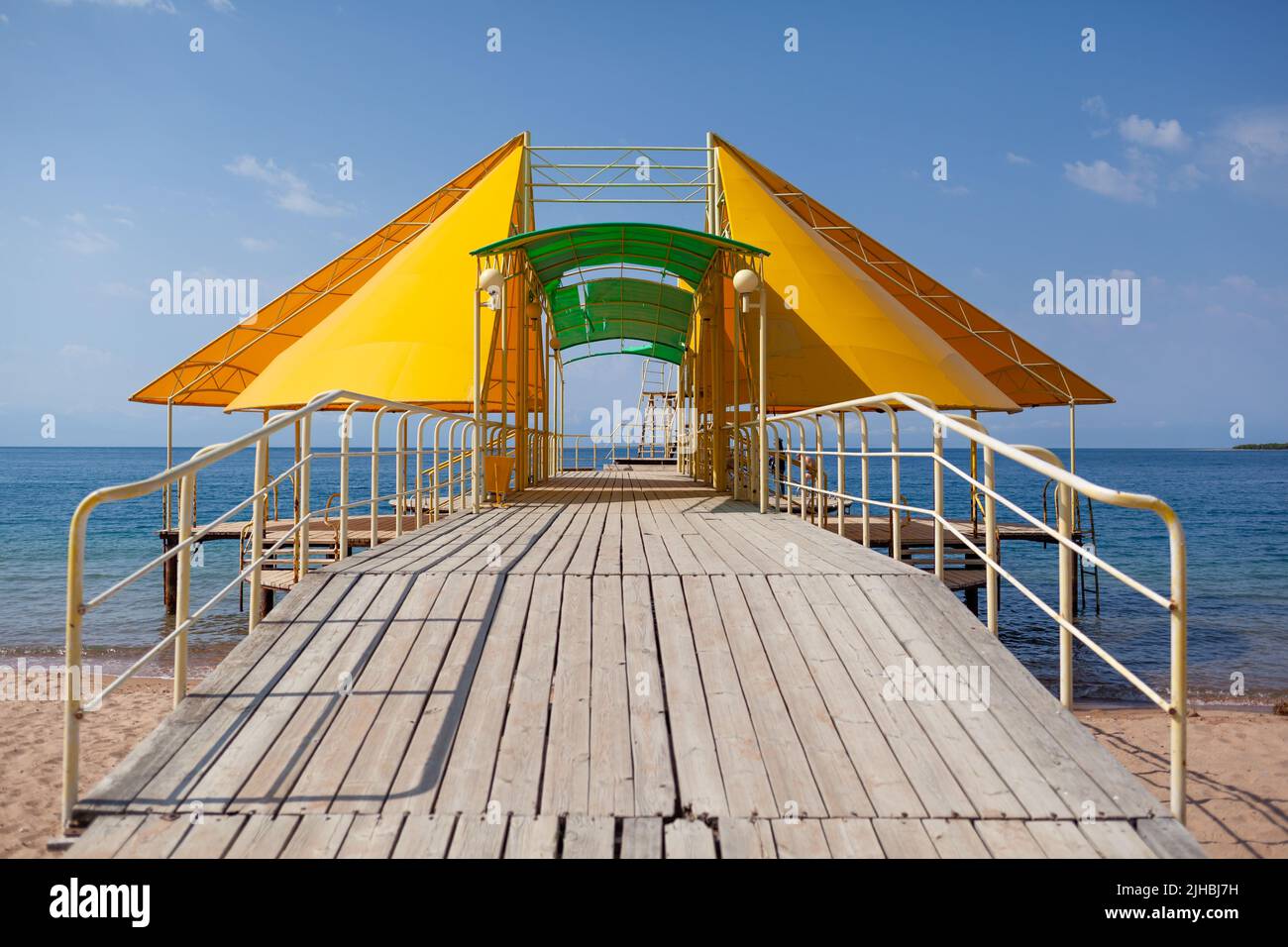 Swimming area or pier on the sea. A large pier with a roof, wooden ...