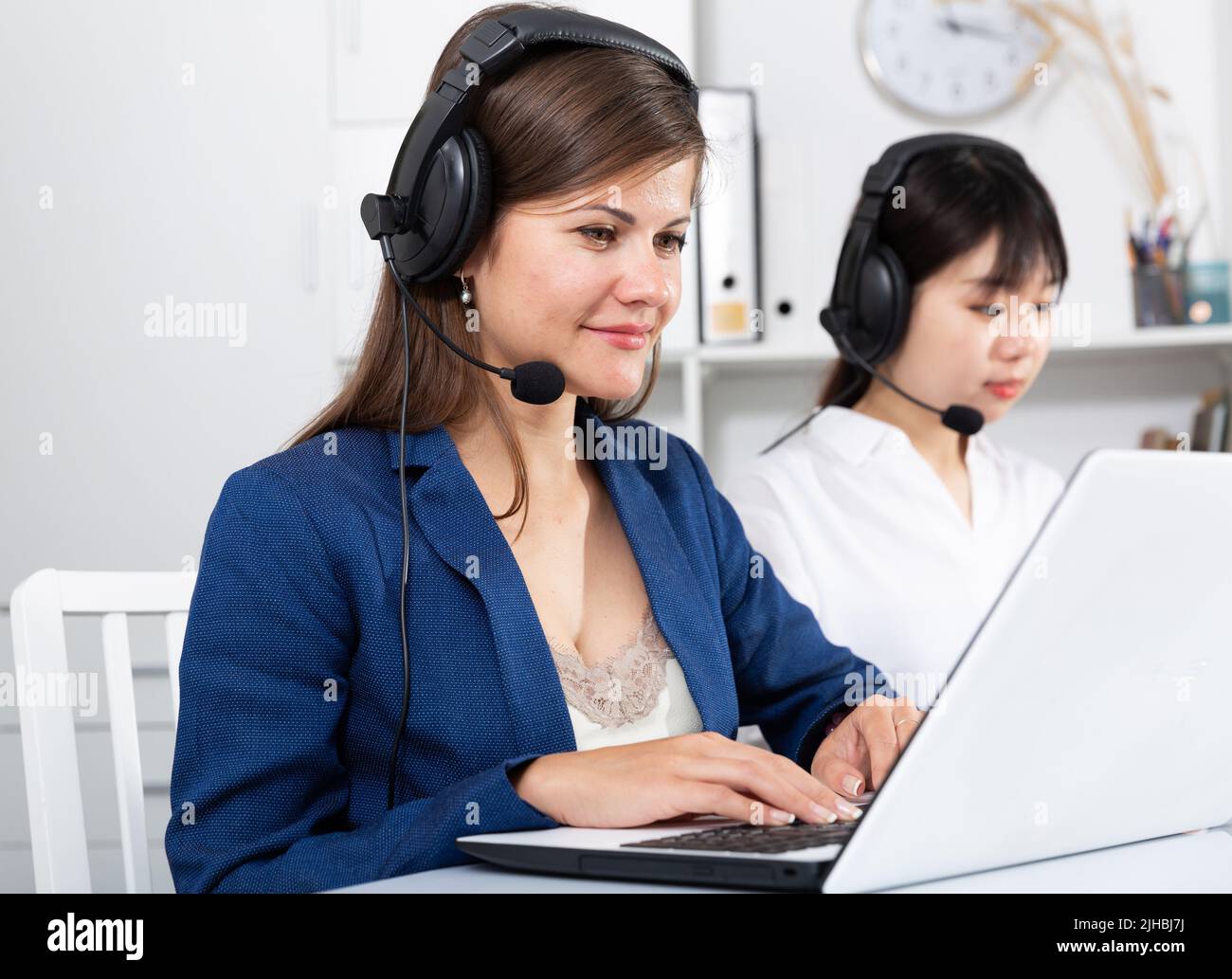 Operators working with computers in an office Stock Photo - Alamy