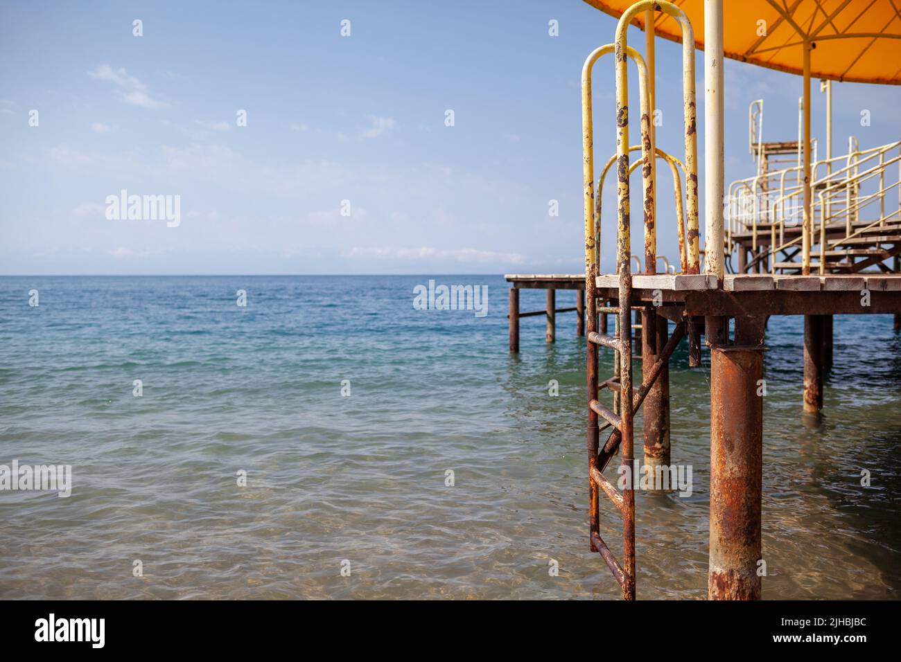 Swimming area or pier on the sea. A large pier with a roof, wooden ...