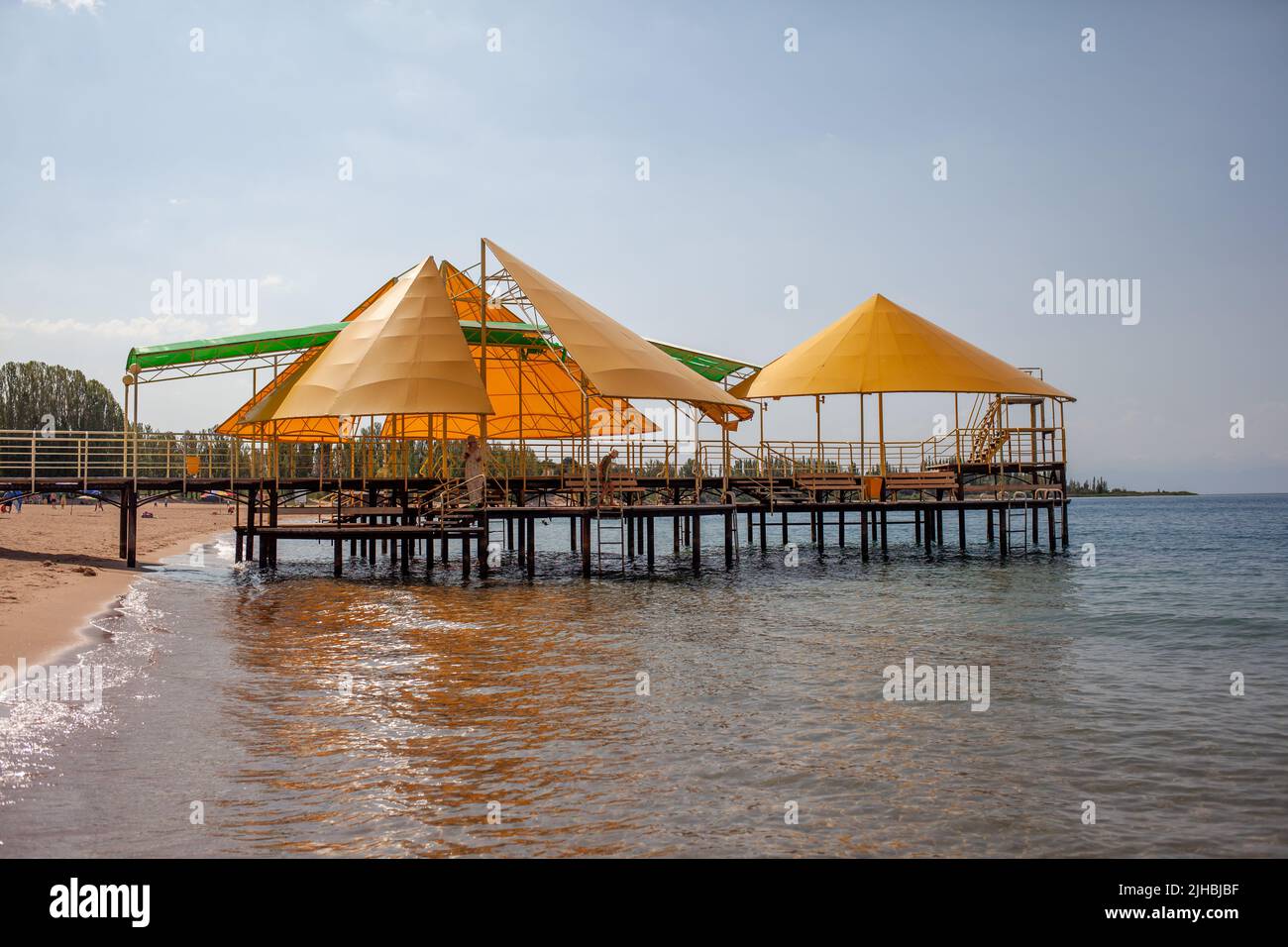 Swimming area or pier on the sea. A large pier with a roof, wooden ...