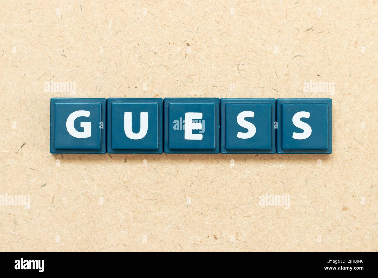 Tile alphabet letter in word guess on wood background Stock Photo - Alamy