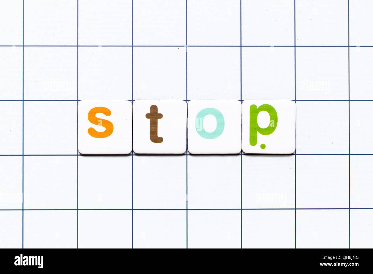 Colorful tile letter in word stop on white grid background Stock Photo ...