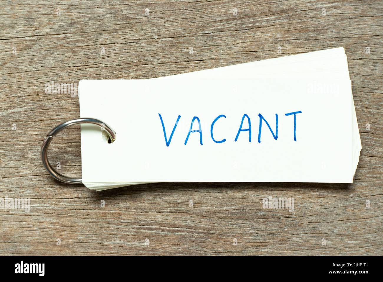 Flash card with handwriting word vacant on wood background Stock Photo ...