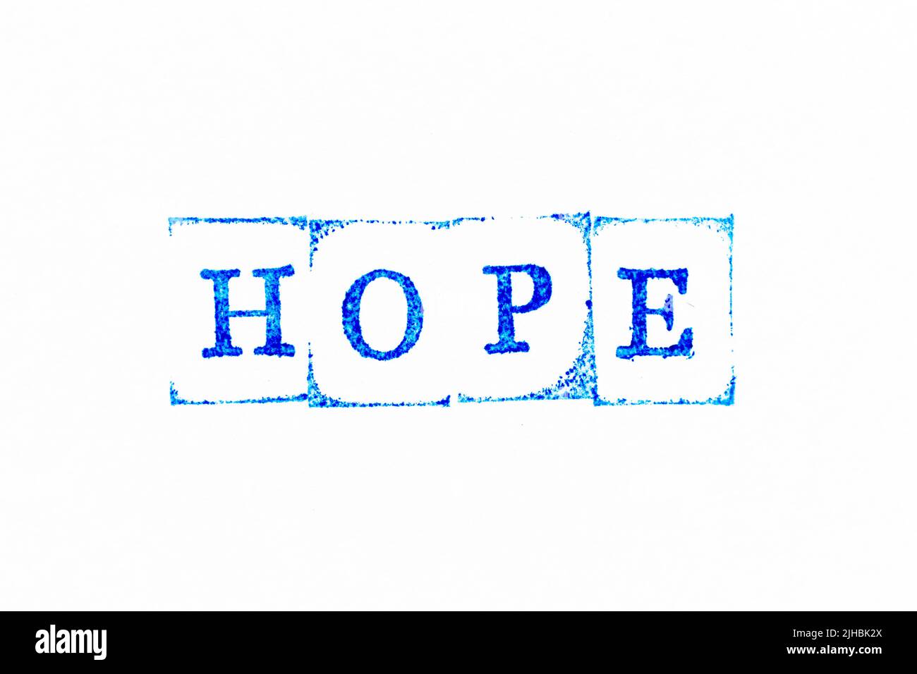 Blue color ink rubber stamp in word hope on white paper background ...