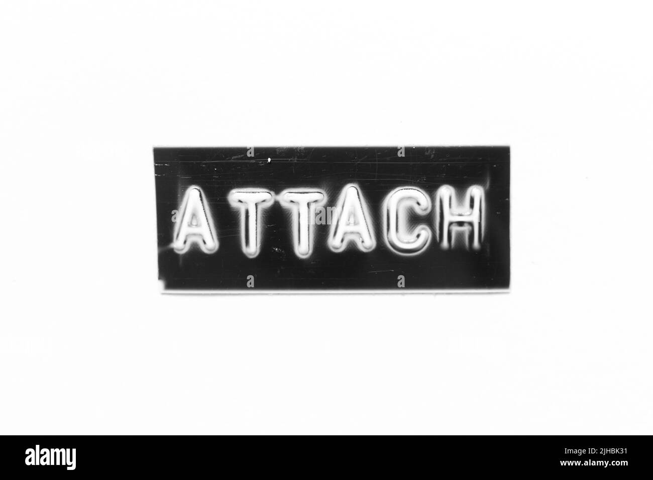 Black color banner that have embossed letter with word attach on white ...