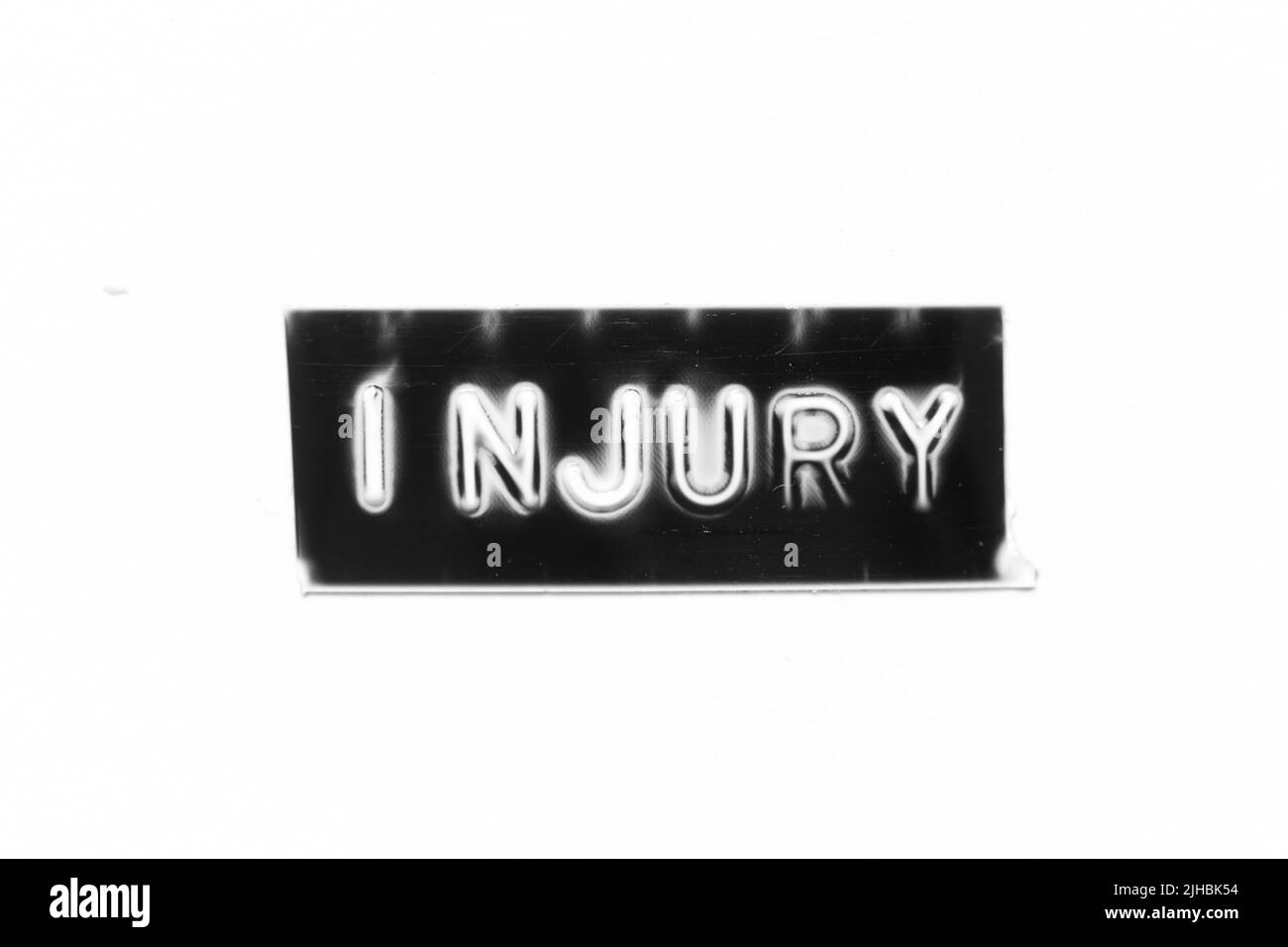 Black color banner that have embossed letter with word injury on white ...