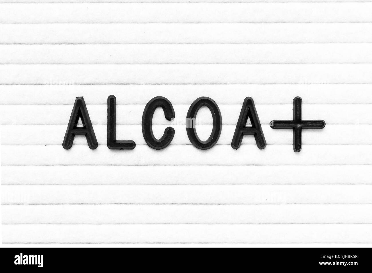 Black color letter in word ALCOA+ on white felt board background Stock ...
