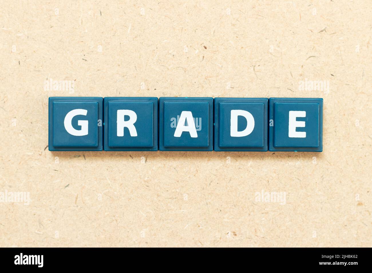 Tile alphabet letter in word grade on wood background Stock Photo - Alamy