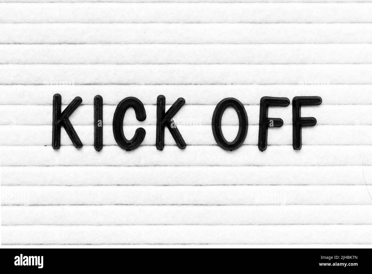Black color letter in word kick off on white felt board background ...