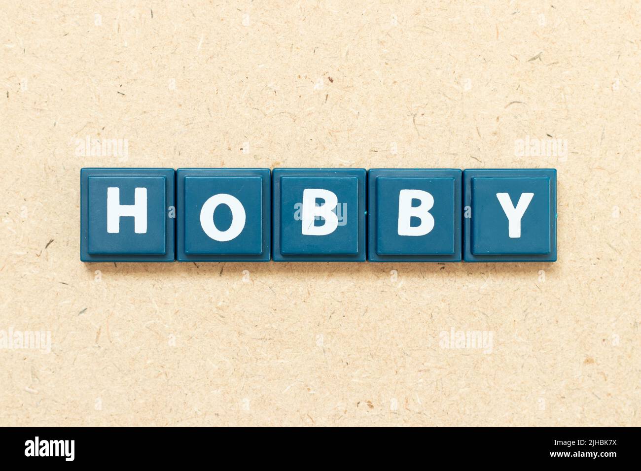 Tile alphabet letter in word hobby on wood background Stock Photo - Alamy