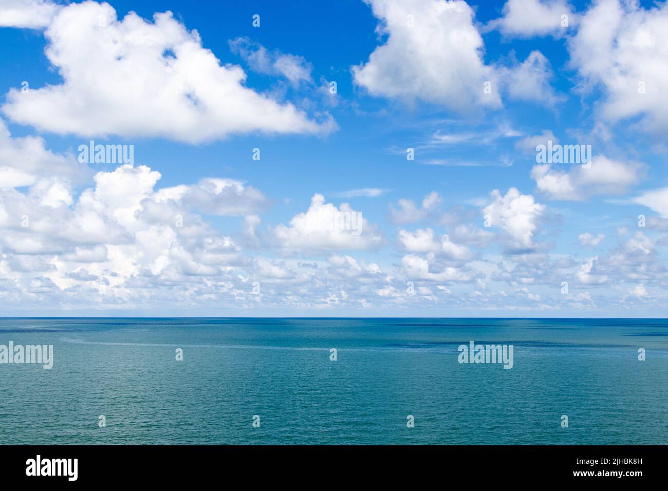 Beautiful calm turquoise color sea and blue sky with white color cloud ...