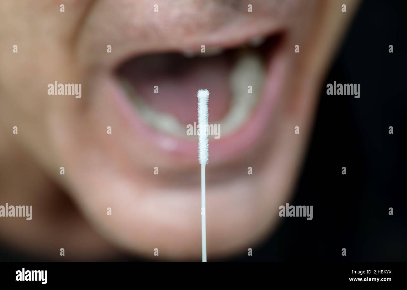 Covid-19 test, nose swab with male face in the background Stock Photo ...
